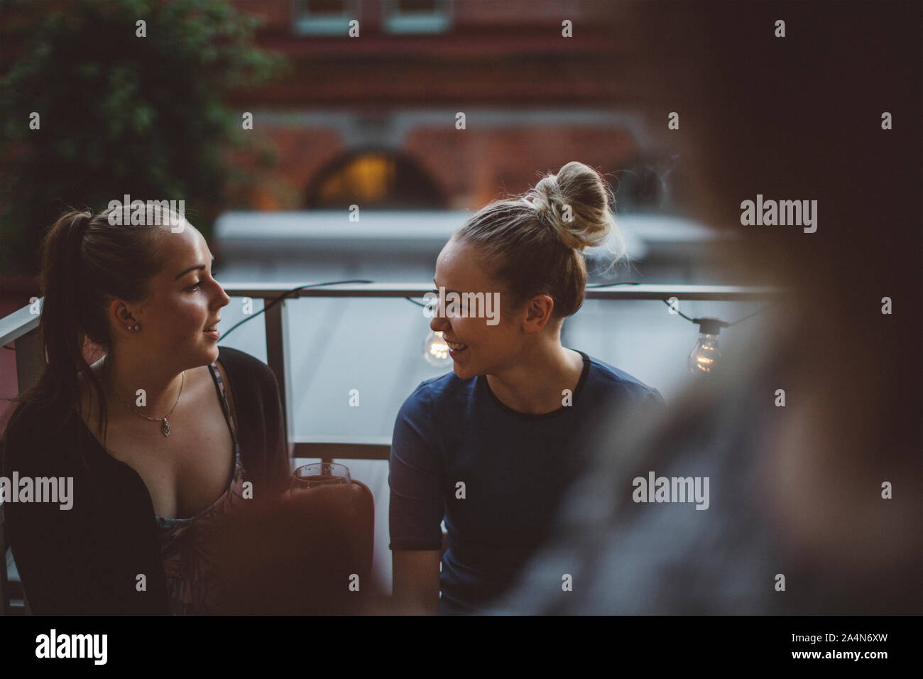 Two people talking on balcony hi-res stock photography and images - Alamy