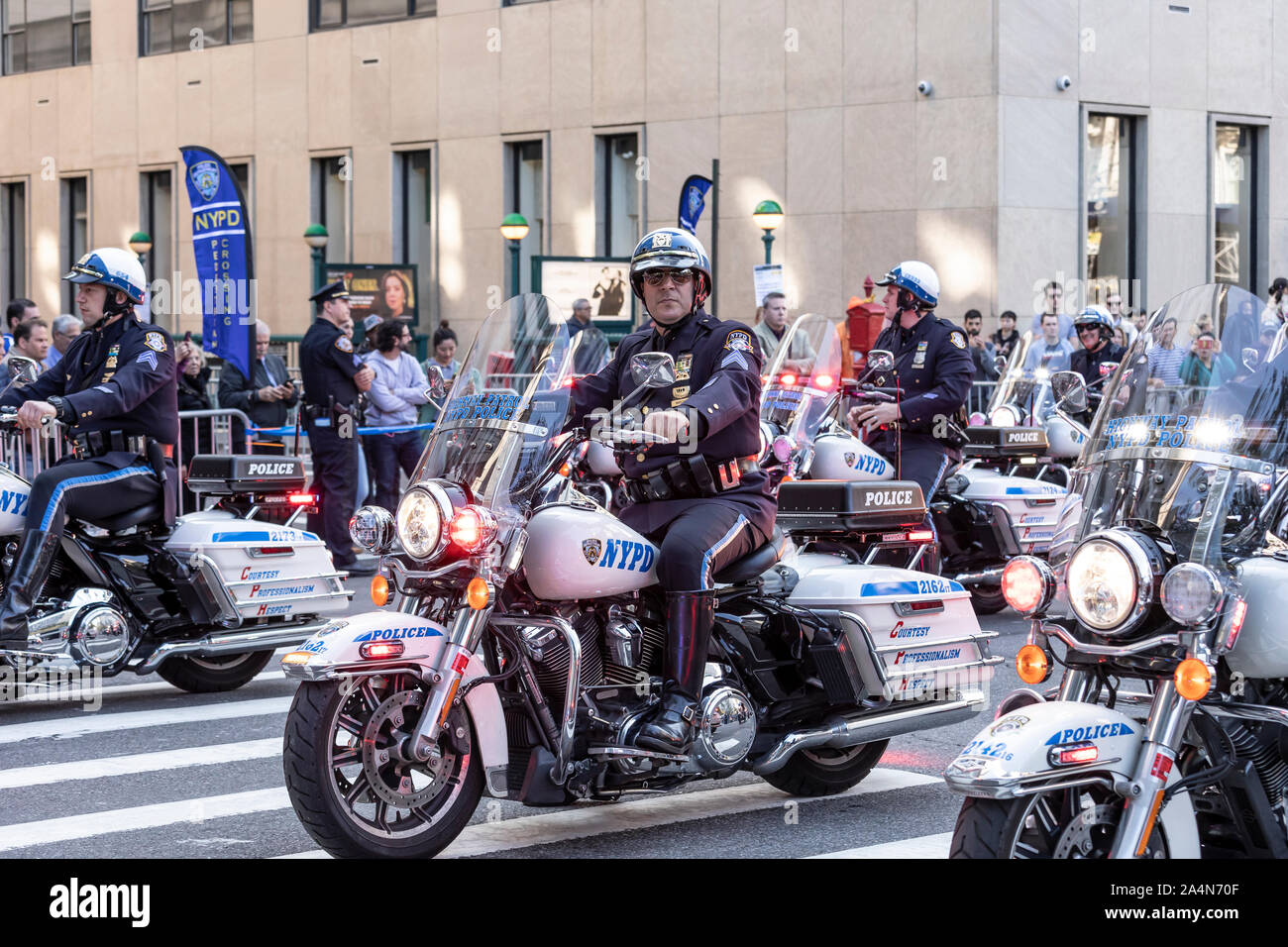 New York, NY, USA - October 14, 2019: Police officers ride bikes along ...
