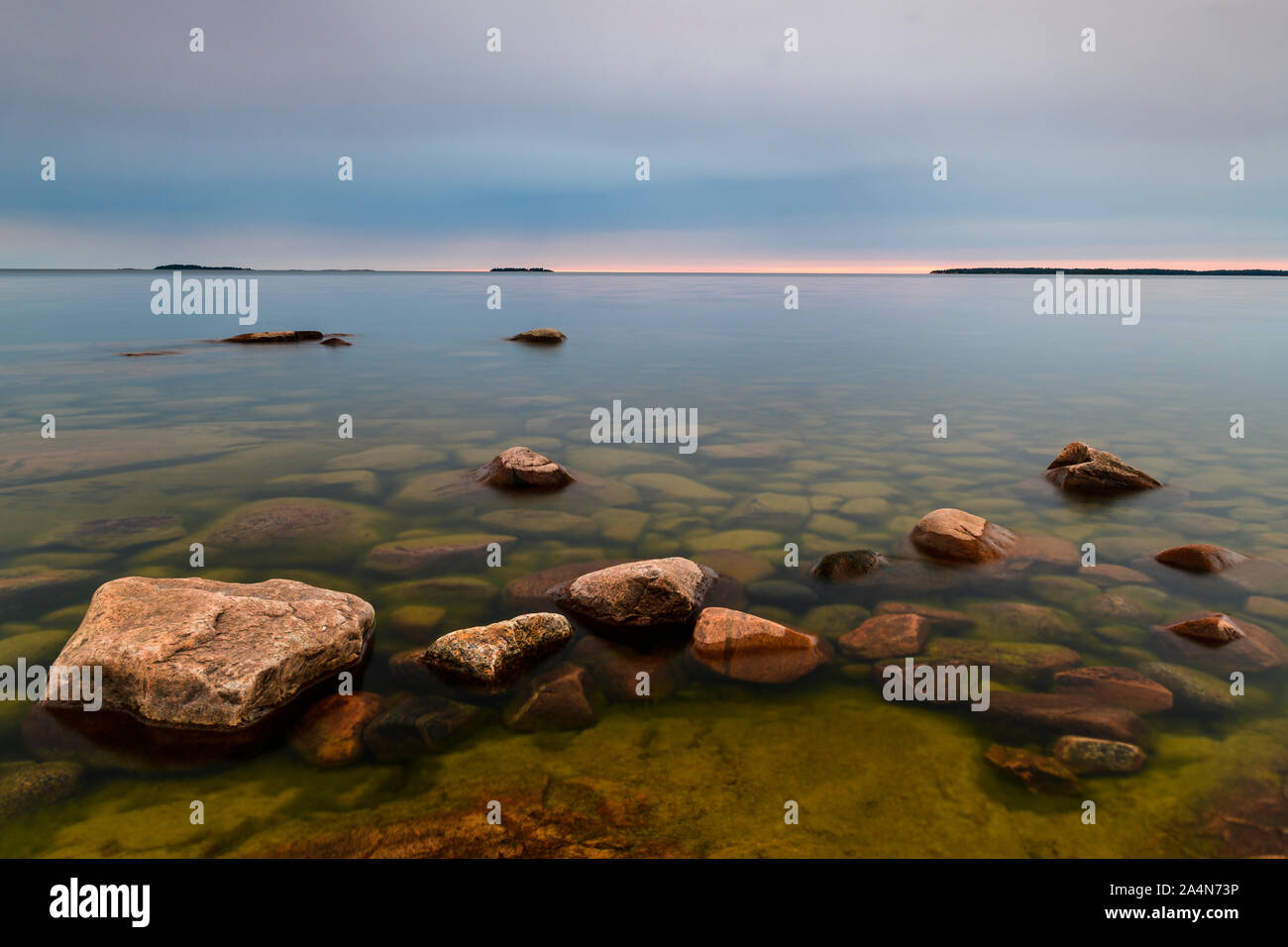 Rock formations by sea at dawn Stock Photo - Alamy