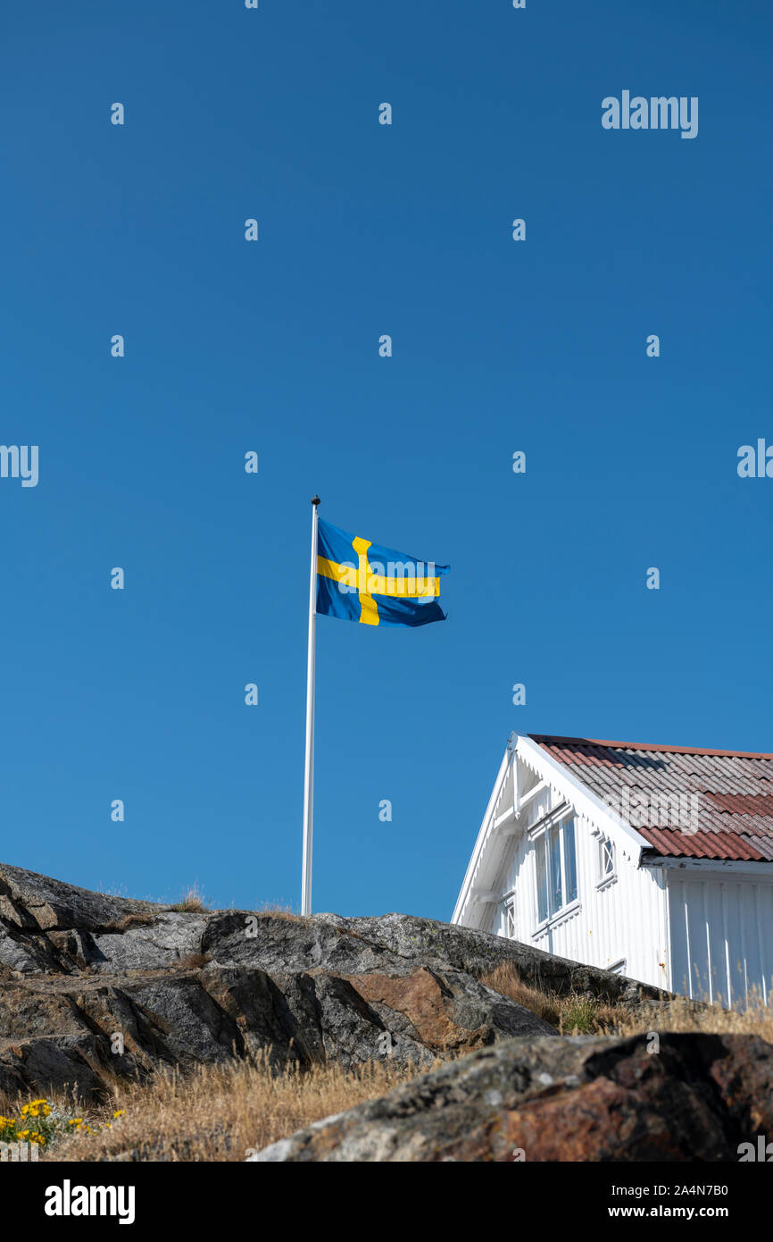 Swedish flag near wooden house Stock Photo - Alamy