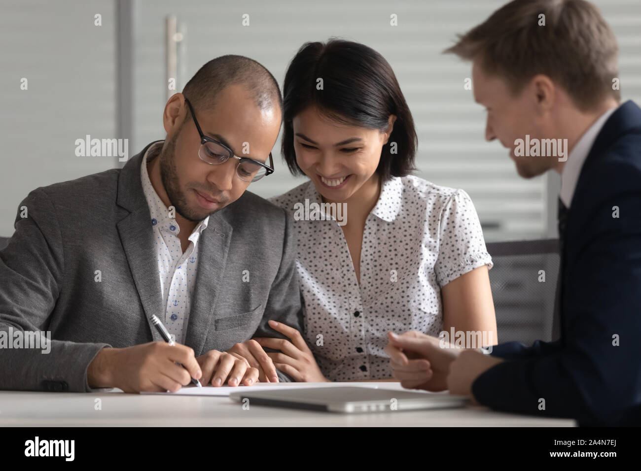 Happy diverse couple signing contract, making purchase deal Stock Photo ...
