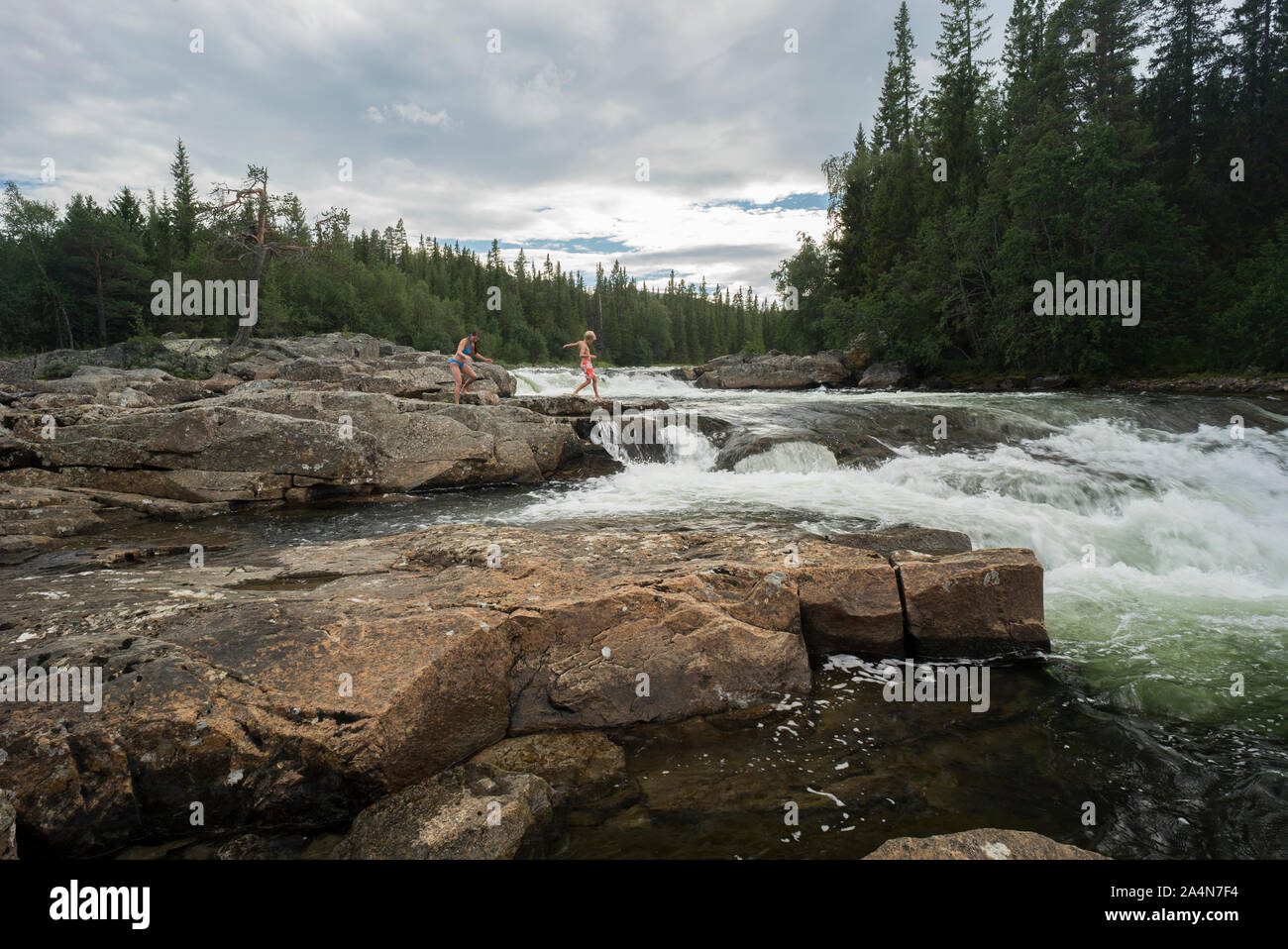 People crossing river Stock Photo - Alamy