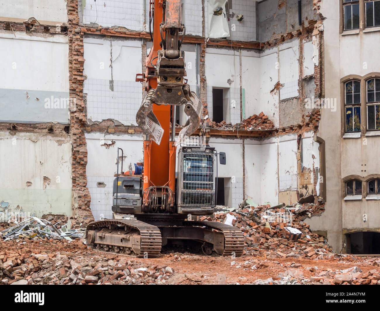 Excavator during demolition work Stock Photo - Alamy