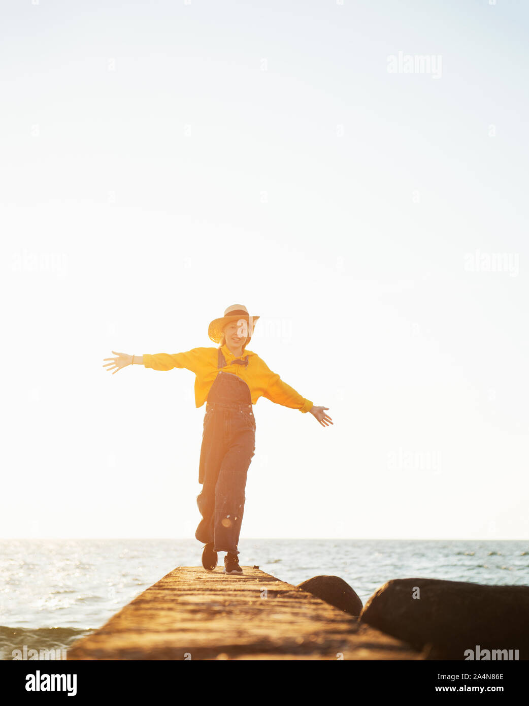 Girl on jetty Stock Photo - Alamy
