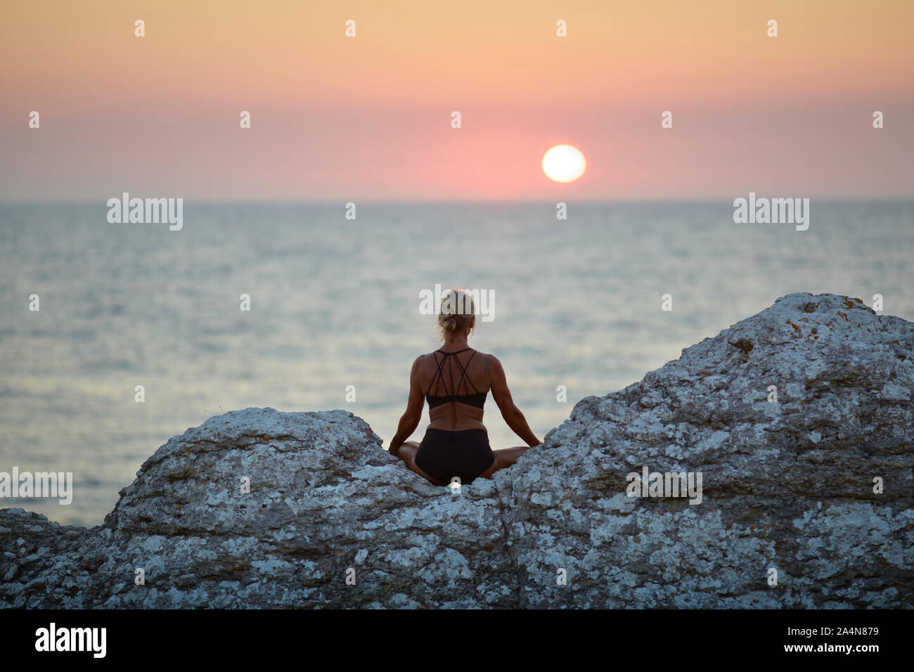 Woman meditating at sea Stock Photo - Alamy