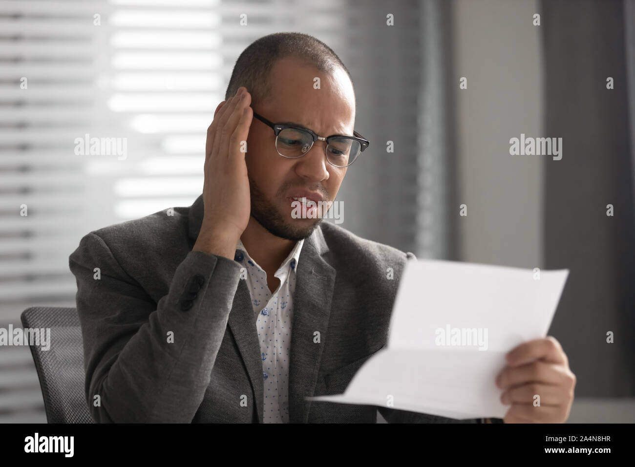 Confused worker reading letter hi-res stock photography and images - Alamy