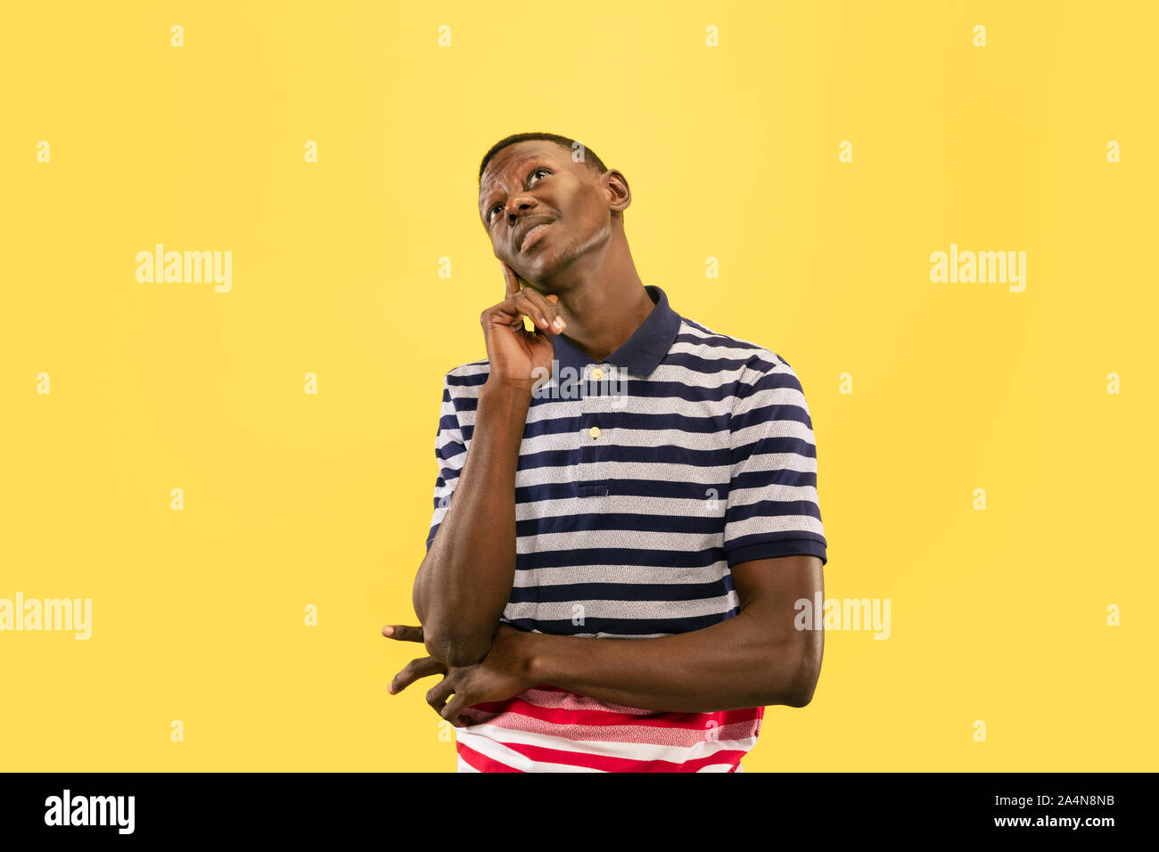 I have a dream. Young african-american man isolated on yellow studio ...