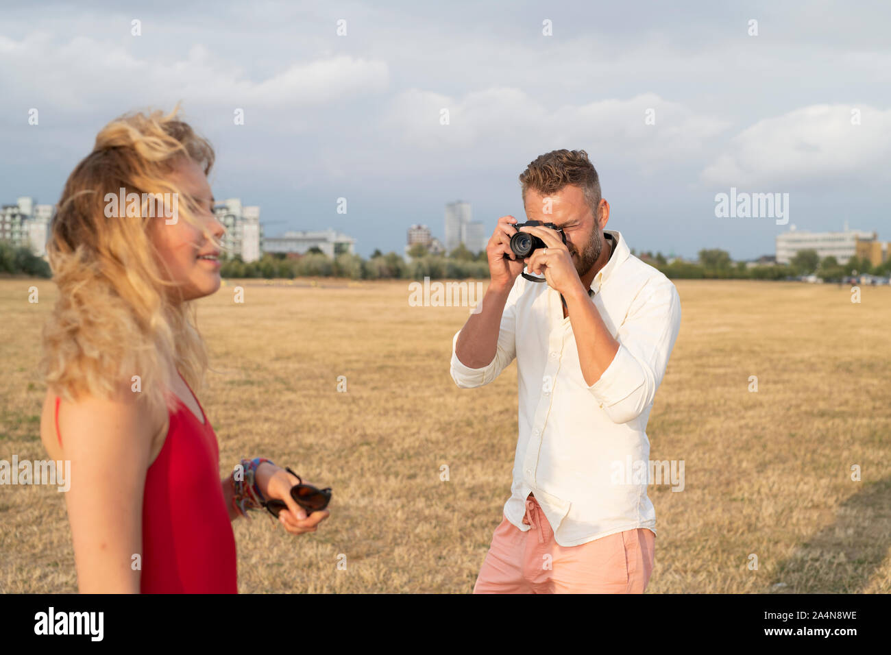 Man photographing young woman Stock Photo - Alamy