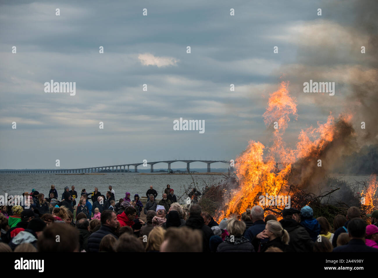 People watching large campfire on beach Stock Photo - Alamy