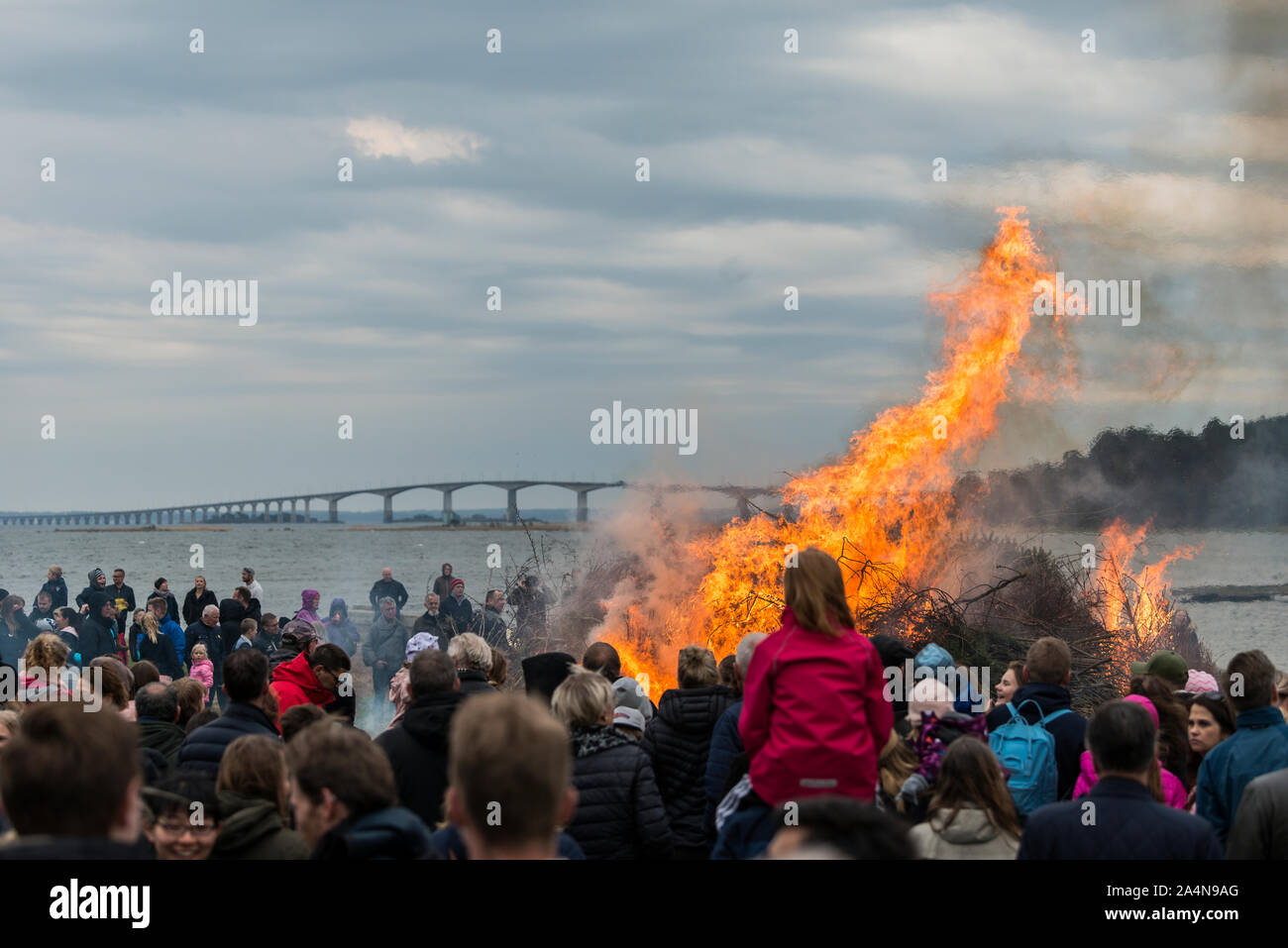 People watching large campfire on beach Stock Photo - Alamy