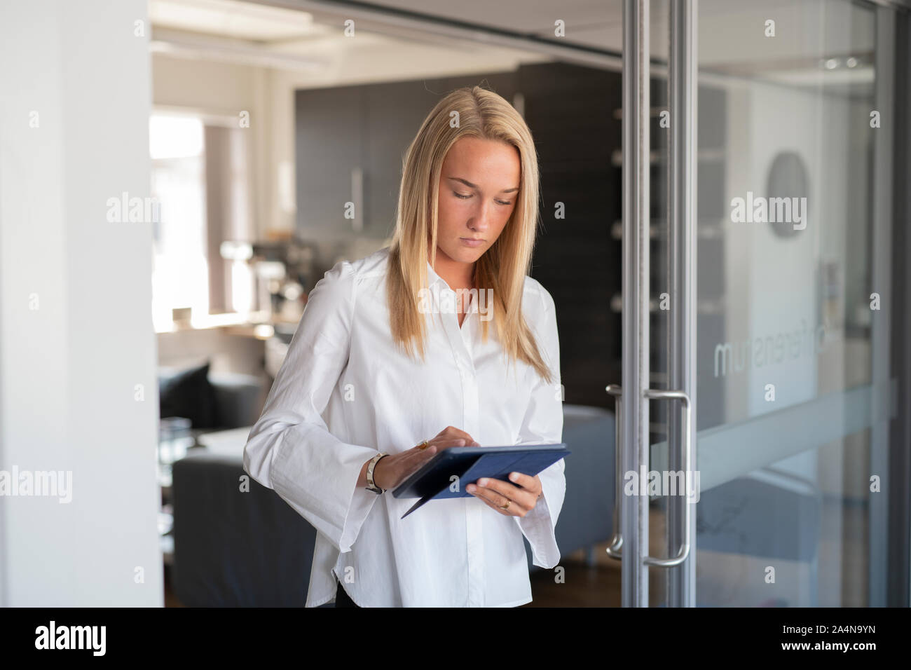 Woman checking tablet Stock Photo - Alamy