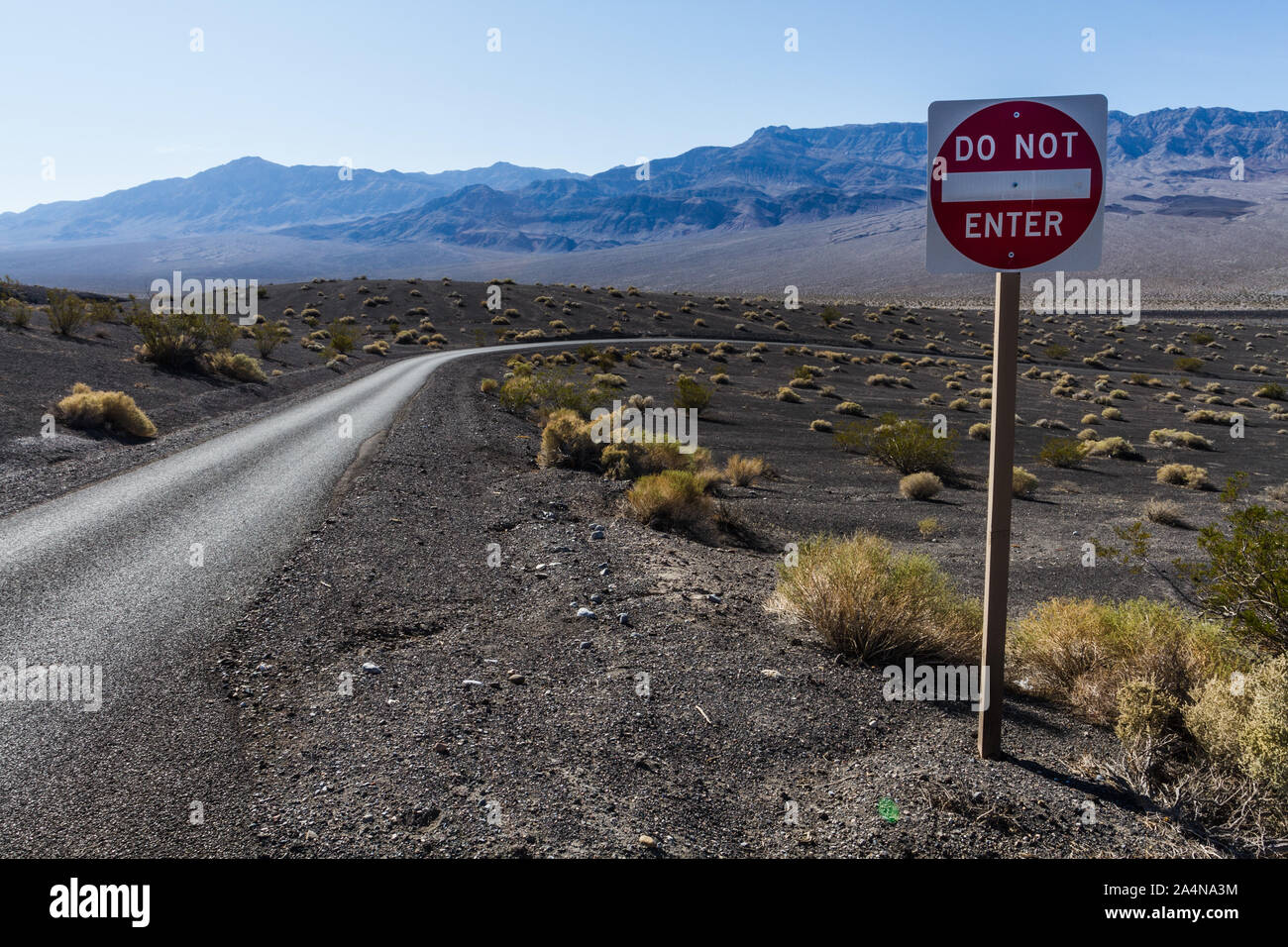An ominous do not enter sign stands at this desert road Stock Photo - Alamy