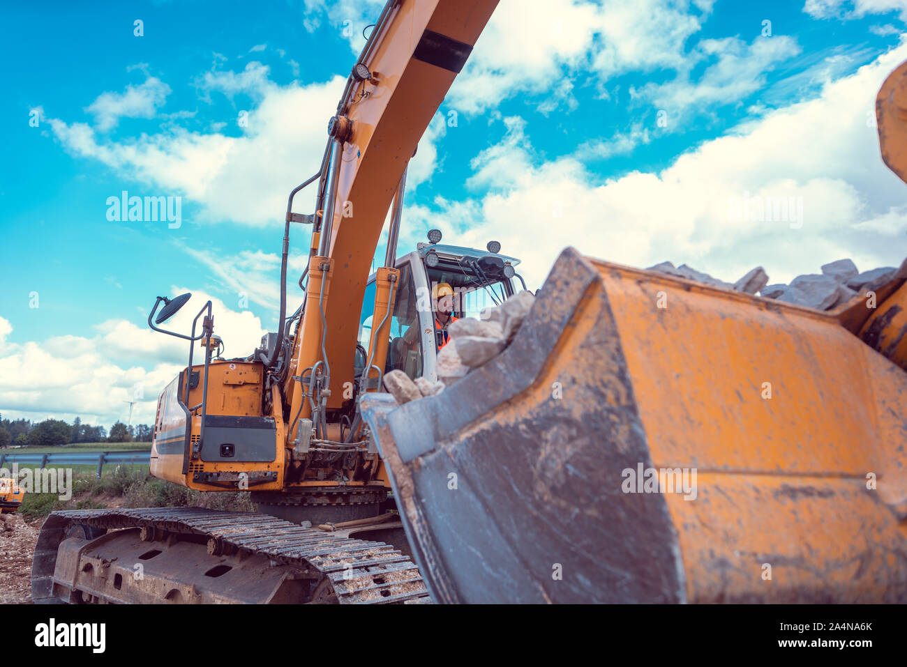 Construction worker operating the crawler excavator Stock Photo - Alamy