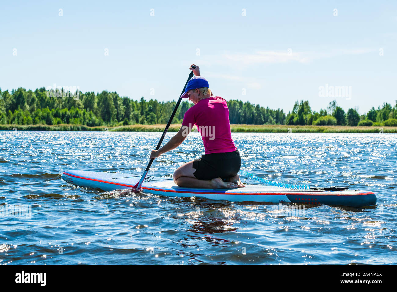 Man on paddleboard Stock Photo - Alamy