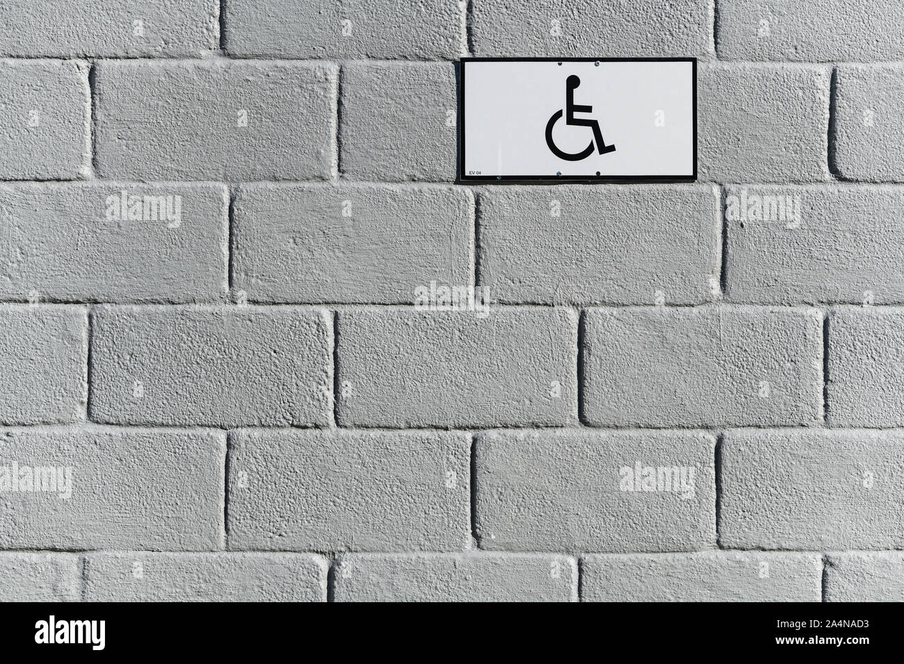 Disabled sign on wall Stock Photo - Alamy