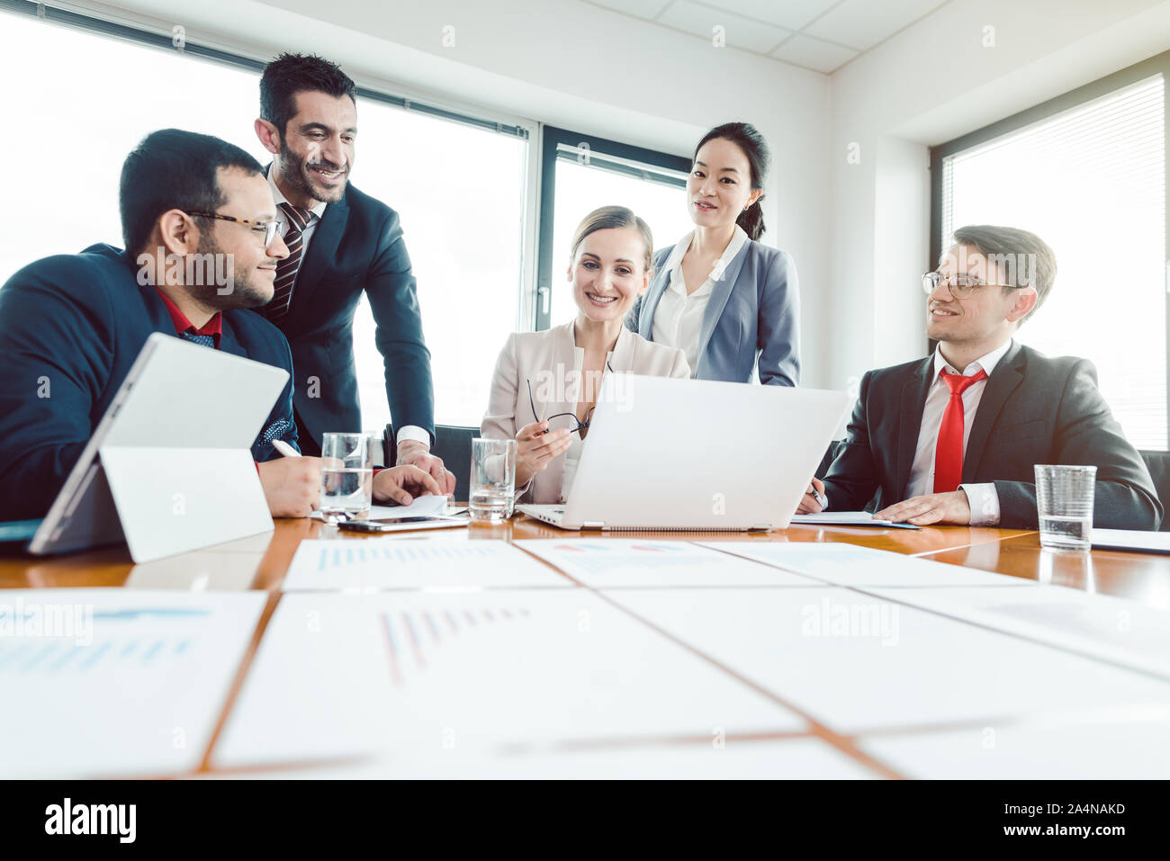 Team of office workers discussing business development Stock Photo - Alamy