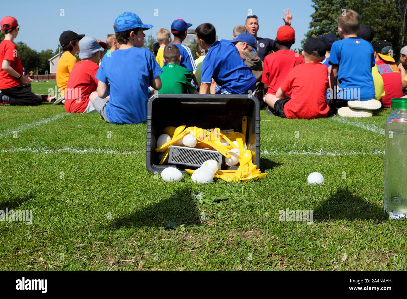 Primary School children outside playing games egg and spoon race on ...