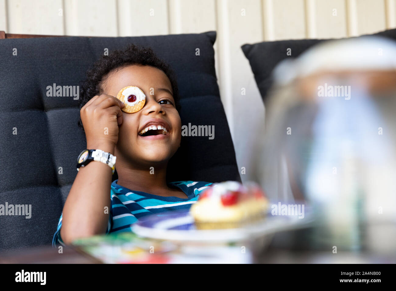 Boy playing with cookie Stock Photo - Alamy