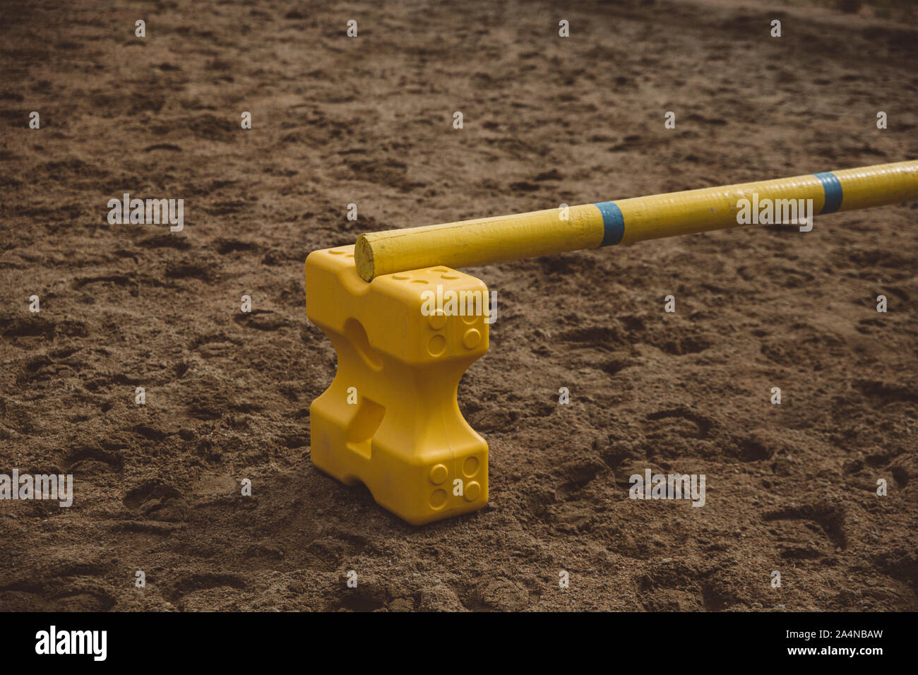 Yellow hurdle on paddock Stock Photo - Alamy