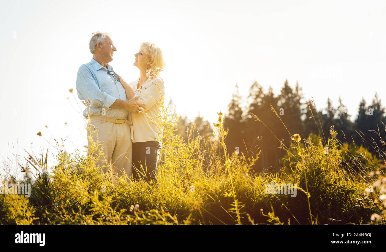 Senior woman and man hugging still being in love Stock Photo - Alamy