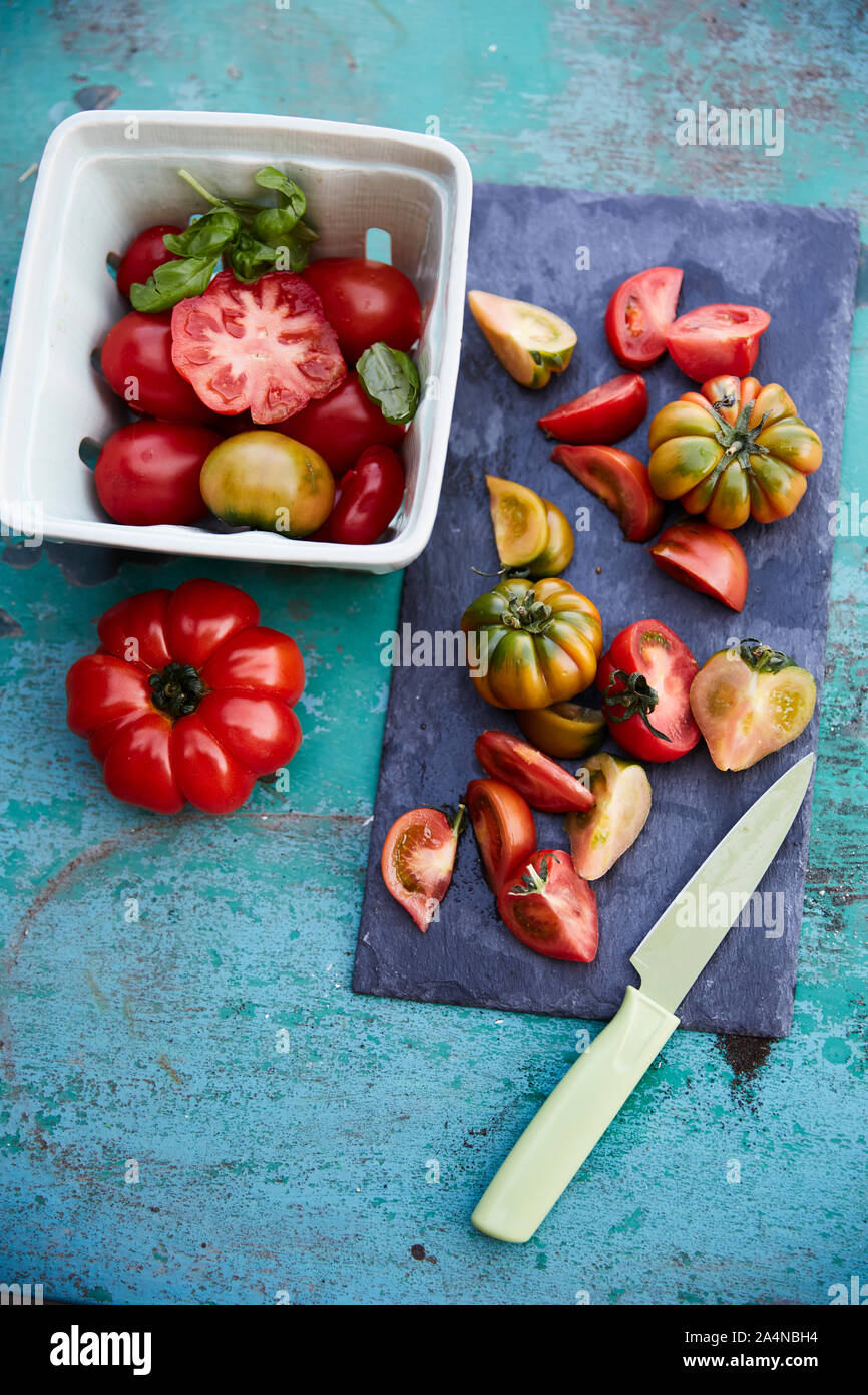 Fresh tomatoes on cutting board and in bowl Stock Photo - Alamy
