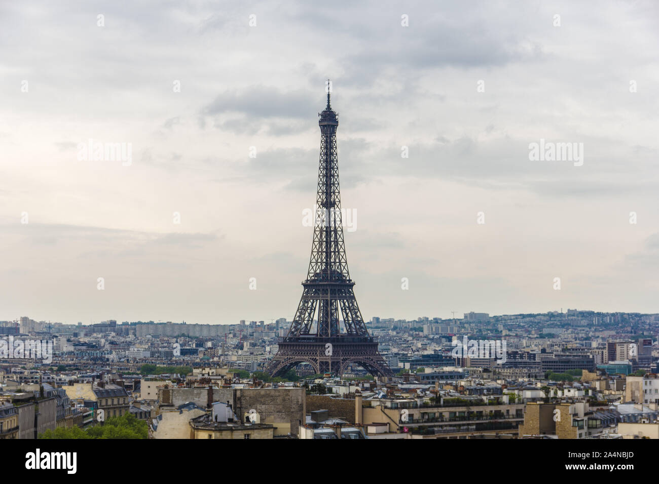 A picture of the Eiffel Tower overlooking the nearby rooftops of Paris ...