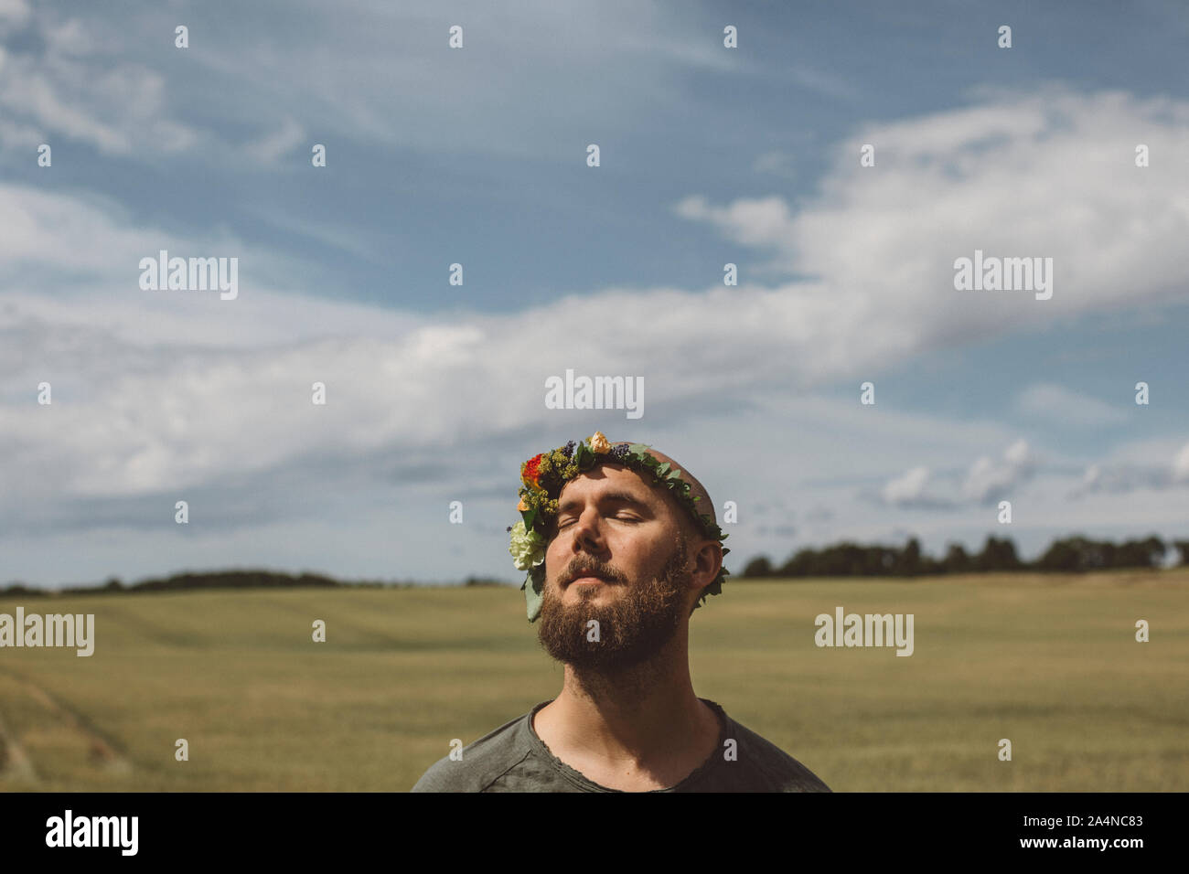 Man wearing flower wreath Stock Photo - Alamy