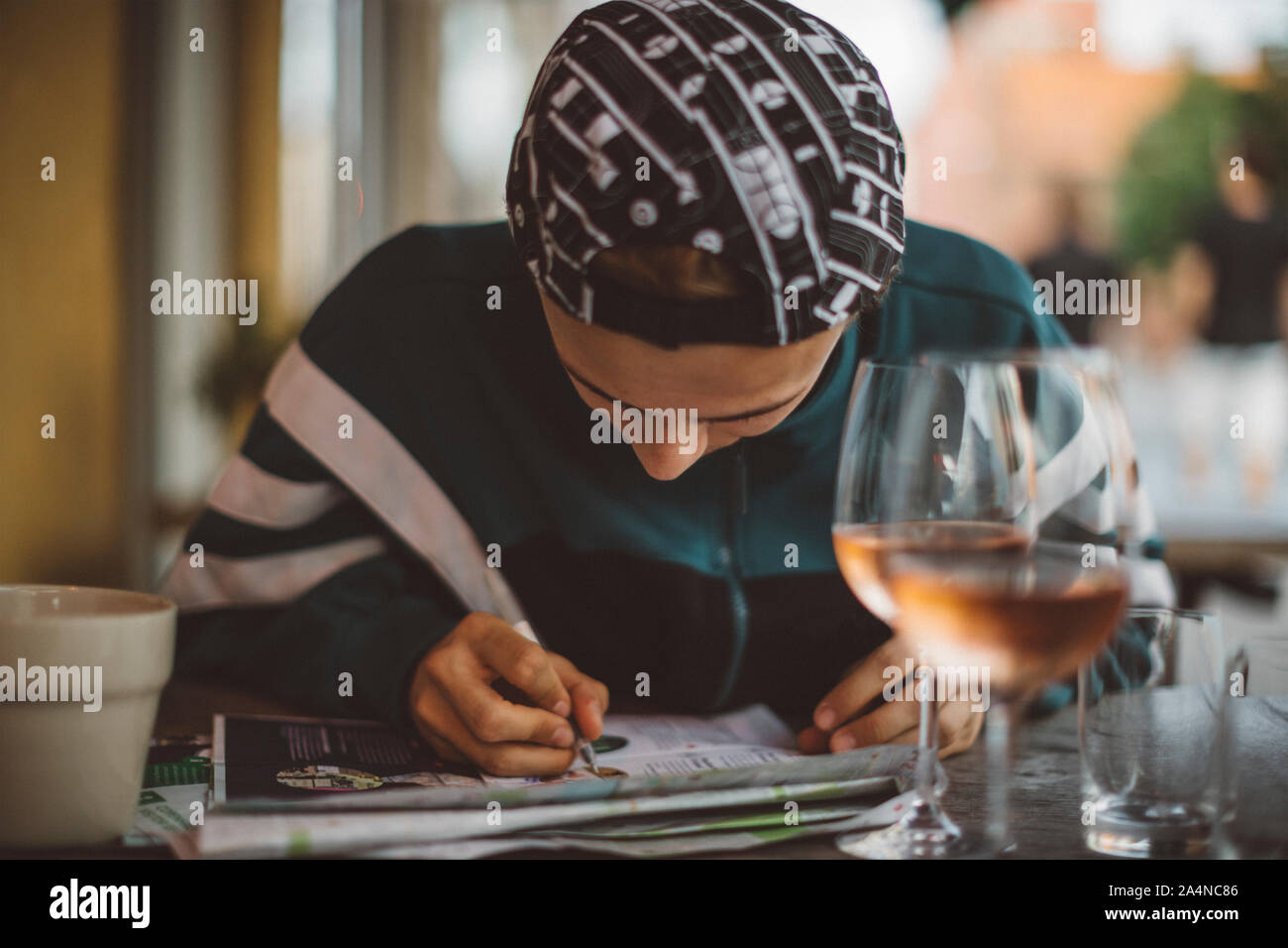 Teenage boy writing in cafe Stock Photo - Alamy