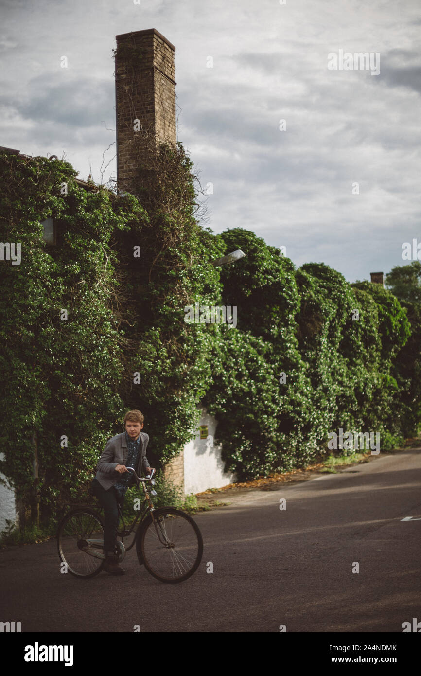 Young man on bicycle Stock Photo - Alamy