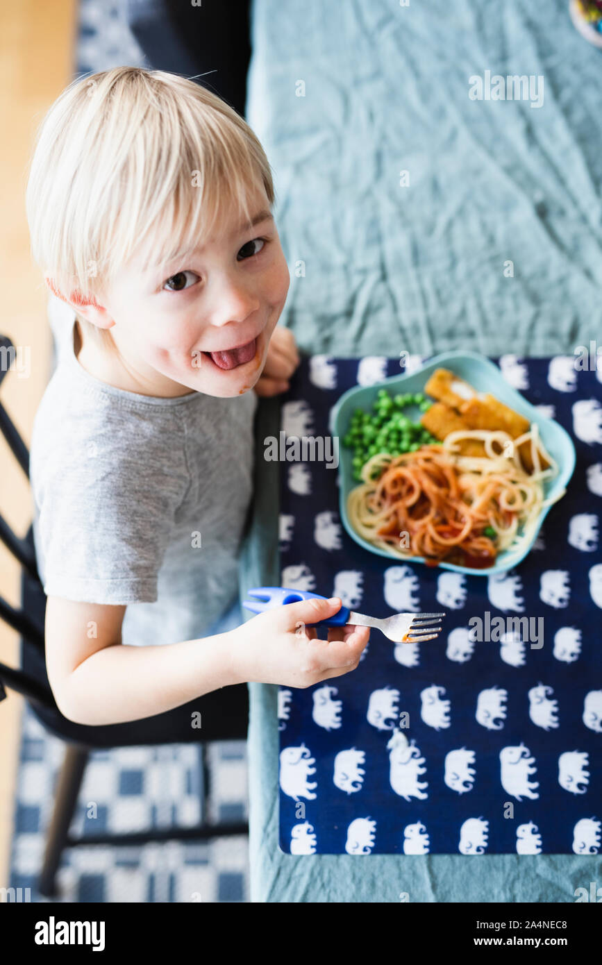 Boy eating pasta Stock Photo - Alamy