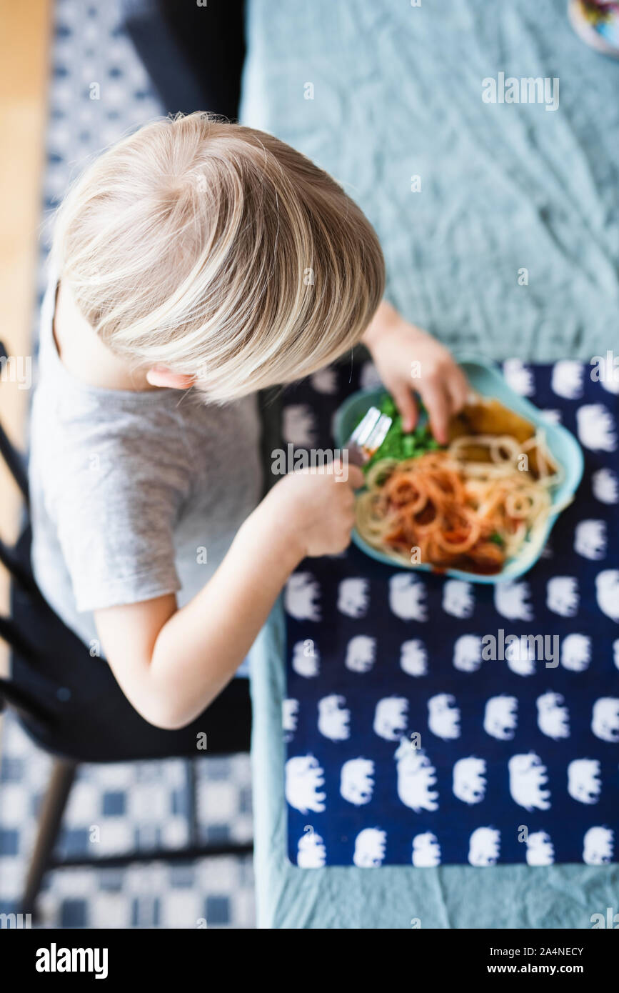 Boy eating pasta Stock Photo - Alamy