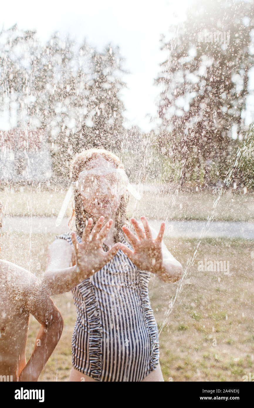 Kids playing with water Stock Photo - Alamy