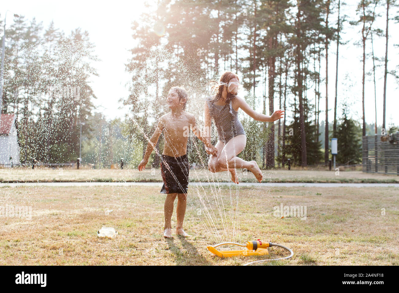Kids playing with water Stock Photo - Alamy