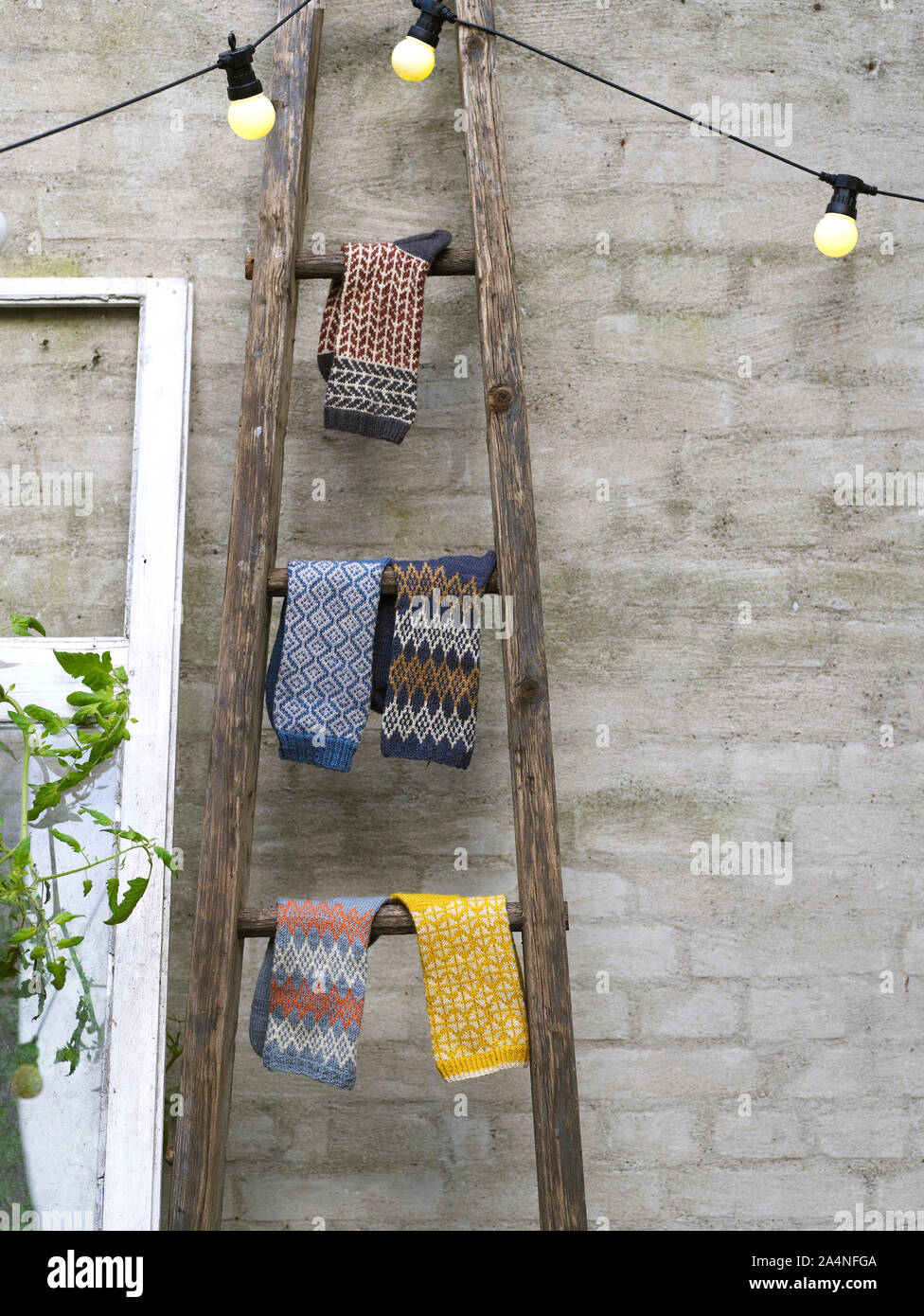 Knitted socks hanging on ladder Stock Photo - Alamy