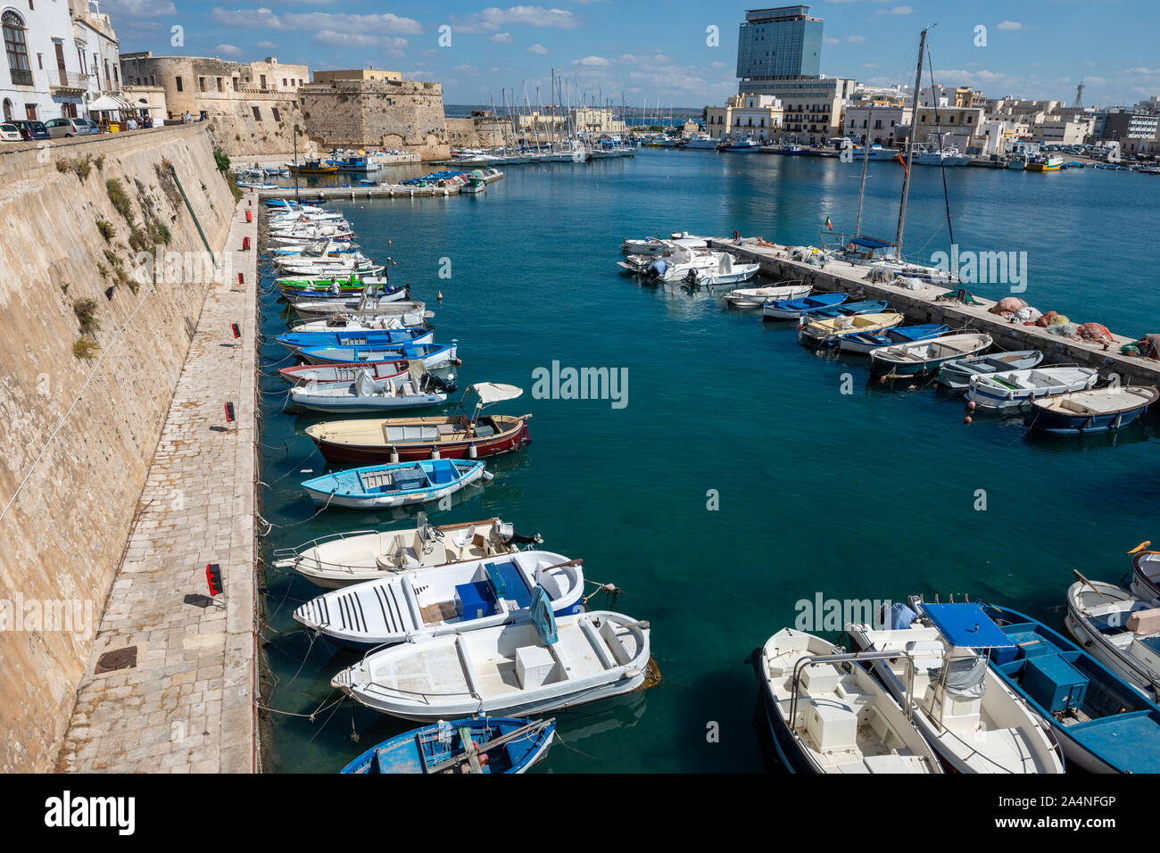 Boats moored in harbour next to old city wall in Gallipoli old town ...