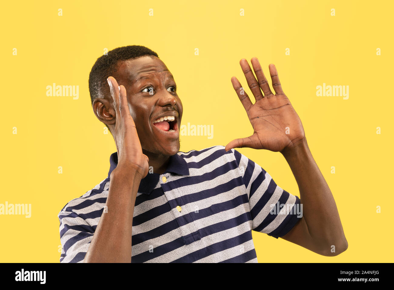Happy young african-american man shouted loud isolated on yellow studio ...