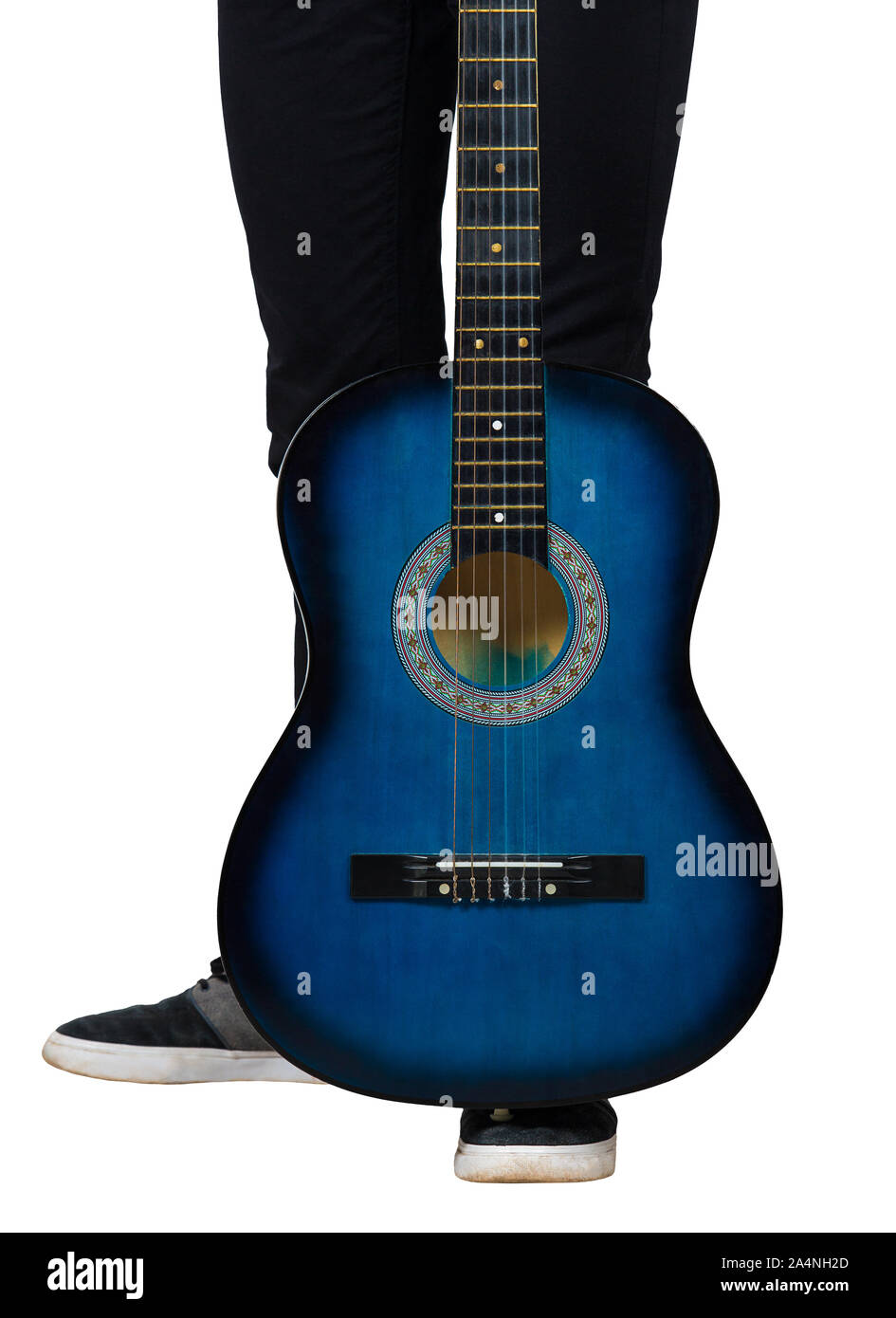 Close up of blue acoustic guitar near the musician legs isolated over ...