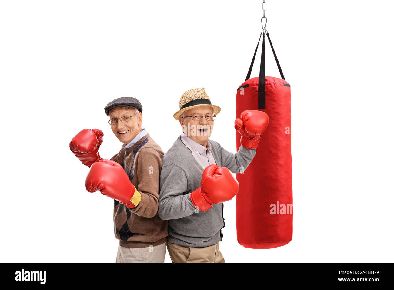 Two active senior men with boxing gloves and a punching bag behind them ...