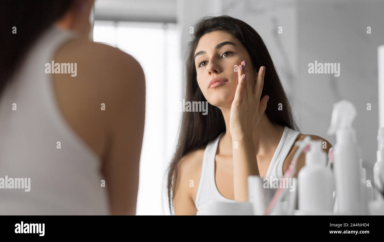 Young Woman Touching Face Skin Standing In Bathroom, Panorama Stock ...