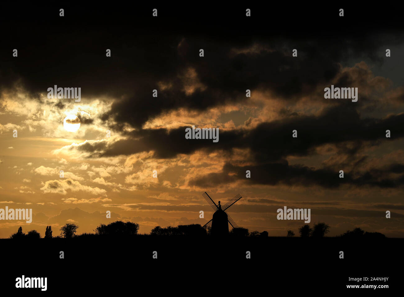 The sun sets behind the Great Haseley windmill in Oxfordshire Stock ...