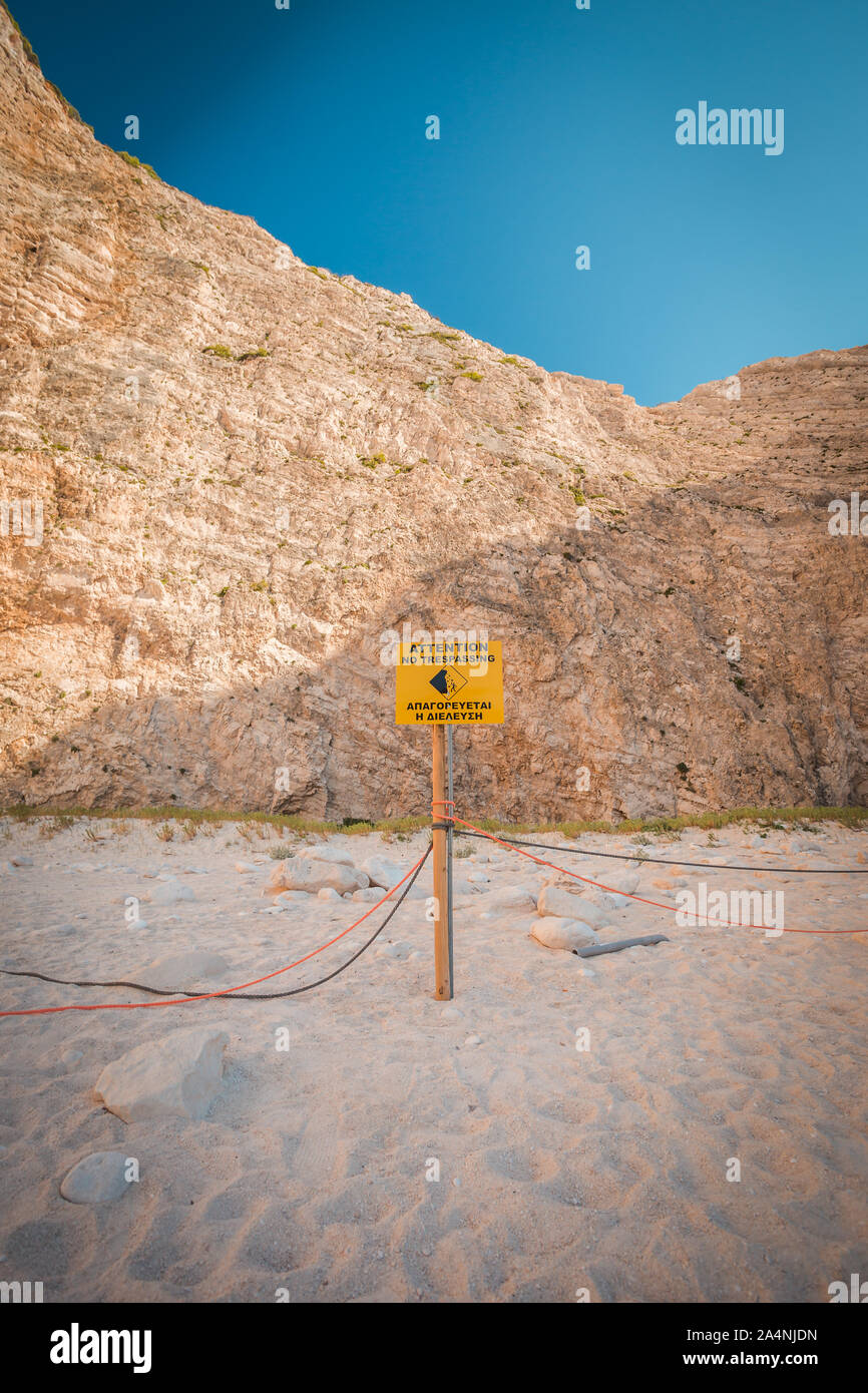 No Trespassing sign on a pole with rope near cliff, warning falling ...