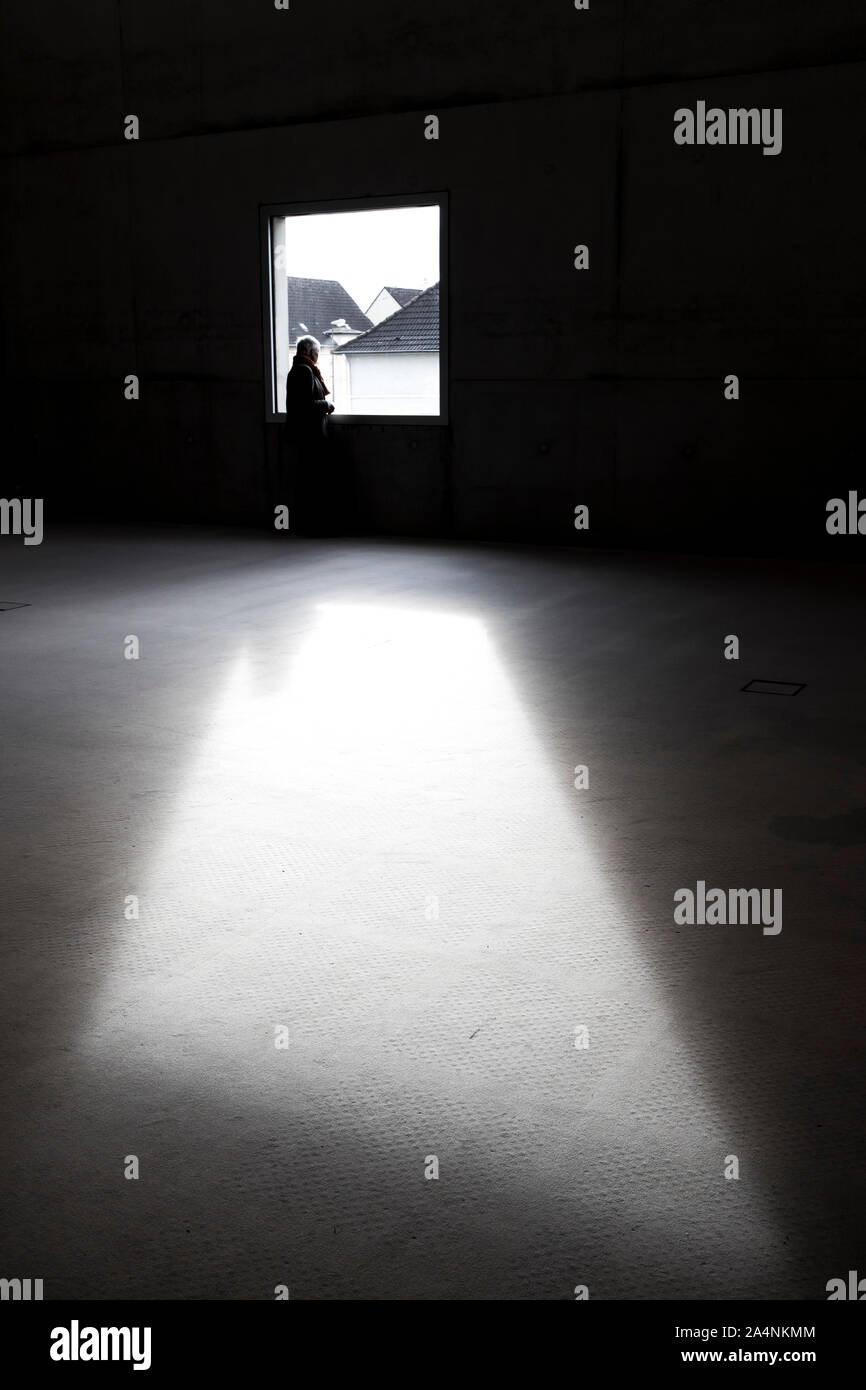 Light falls through a square window into a large, empty room Stock ...