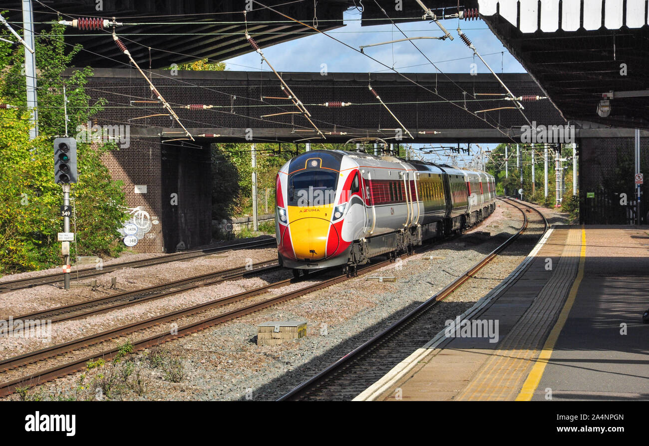 LNER Azuma speeds south through the station at Huntingdon ...