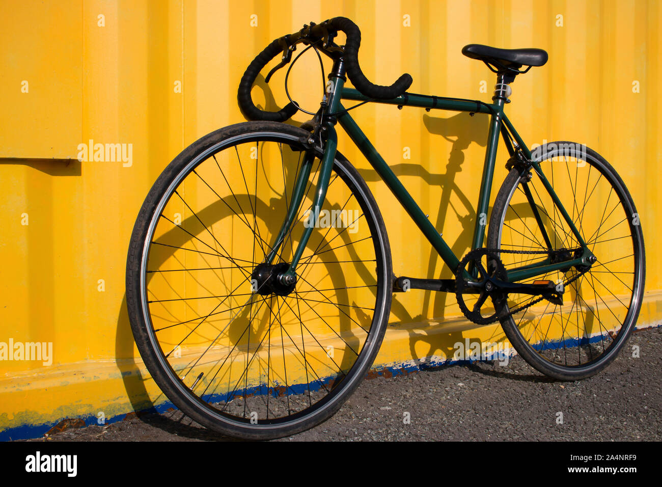 Green sport bike on a yellow background Stock Photo - Alamy