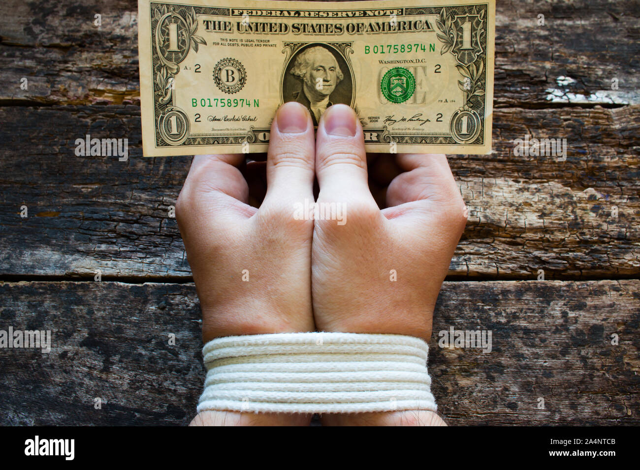 hands bound men and money in the hands - a symbol of slavery Stock ...