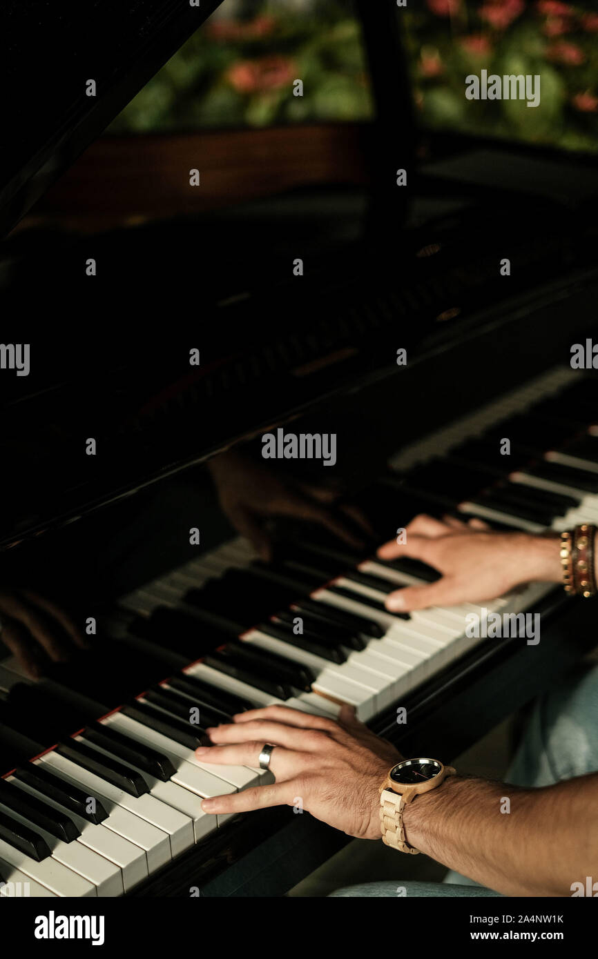 A Man playing music on a piano Stock Photo - Alamy