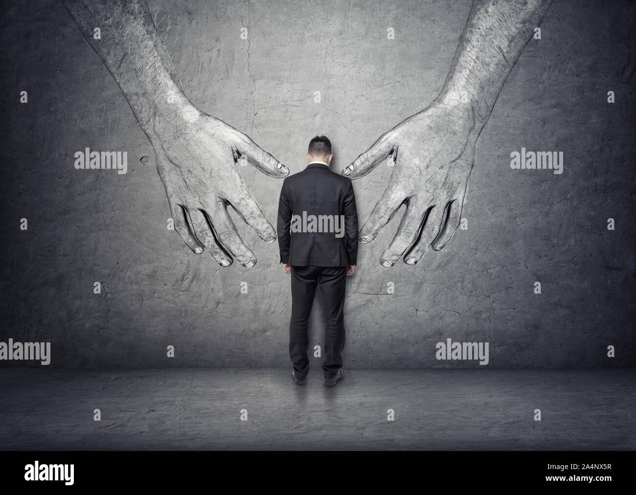 Back view of a businessman standing between big hand drawn hands Stock ...