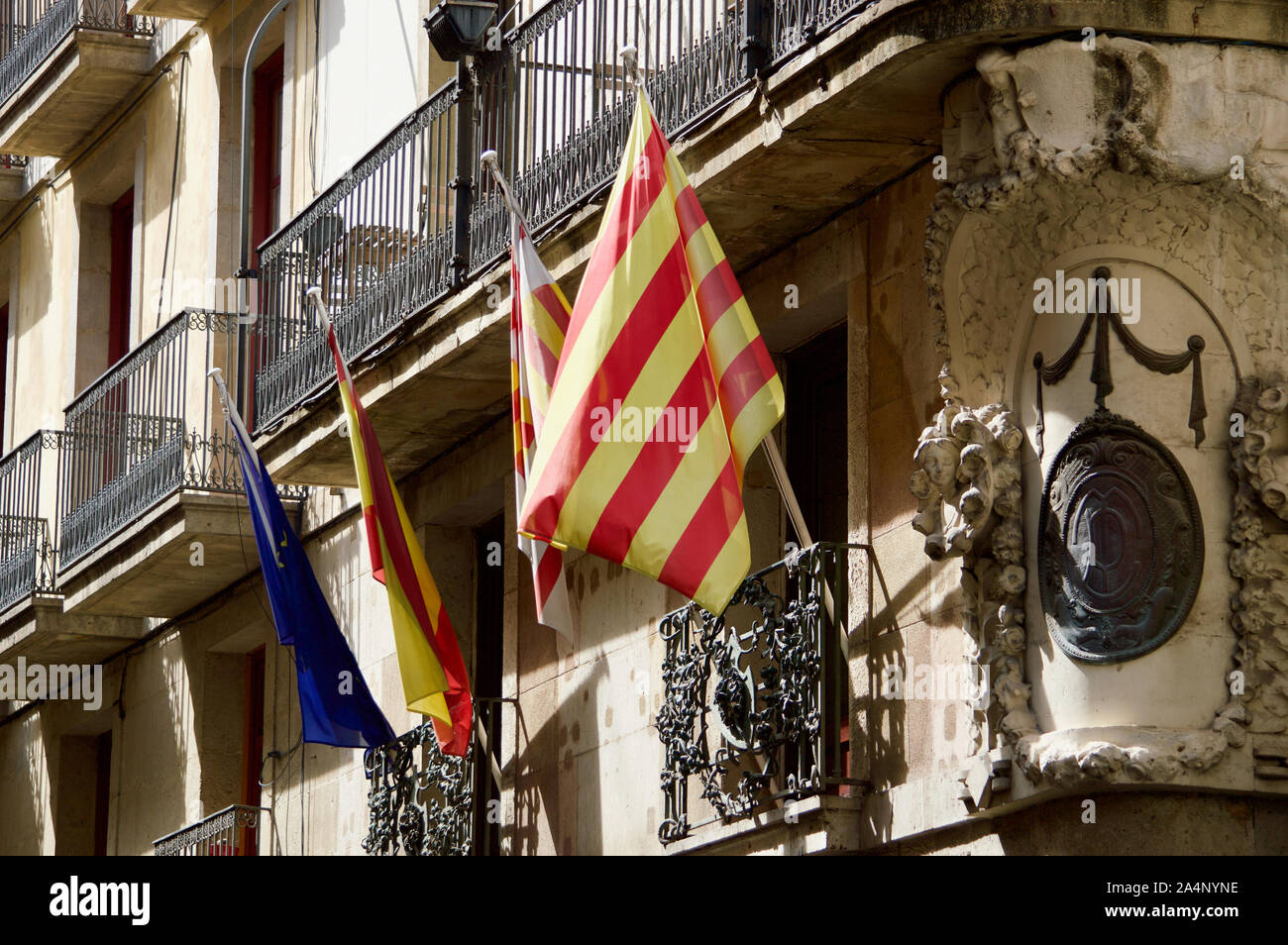 The Senyera flag hanging from buildings on a street in Barcelona, Spain ...
