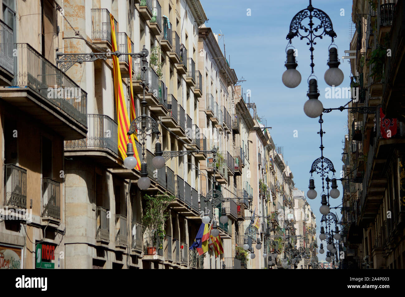The Senyera flag hanging from buildings on a street in Barcelona, Spain ...
