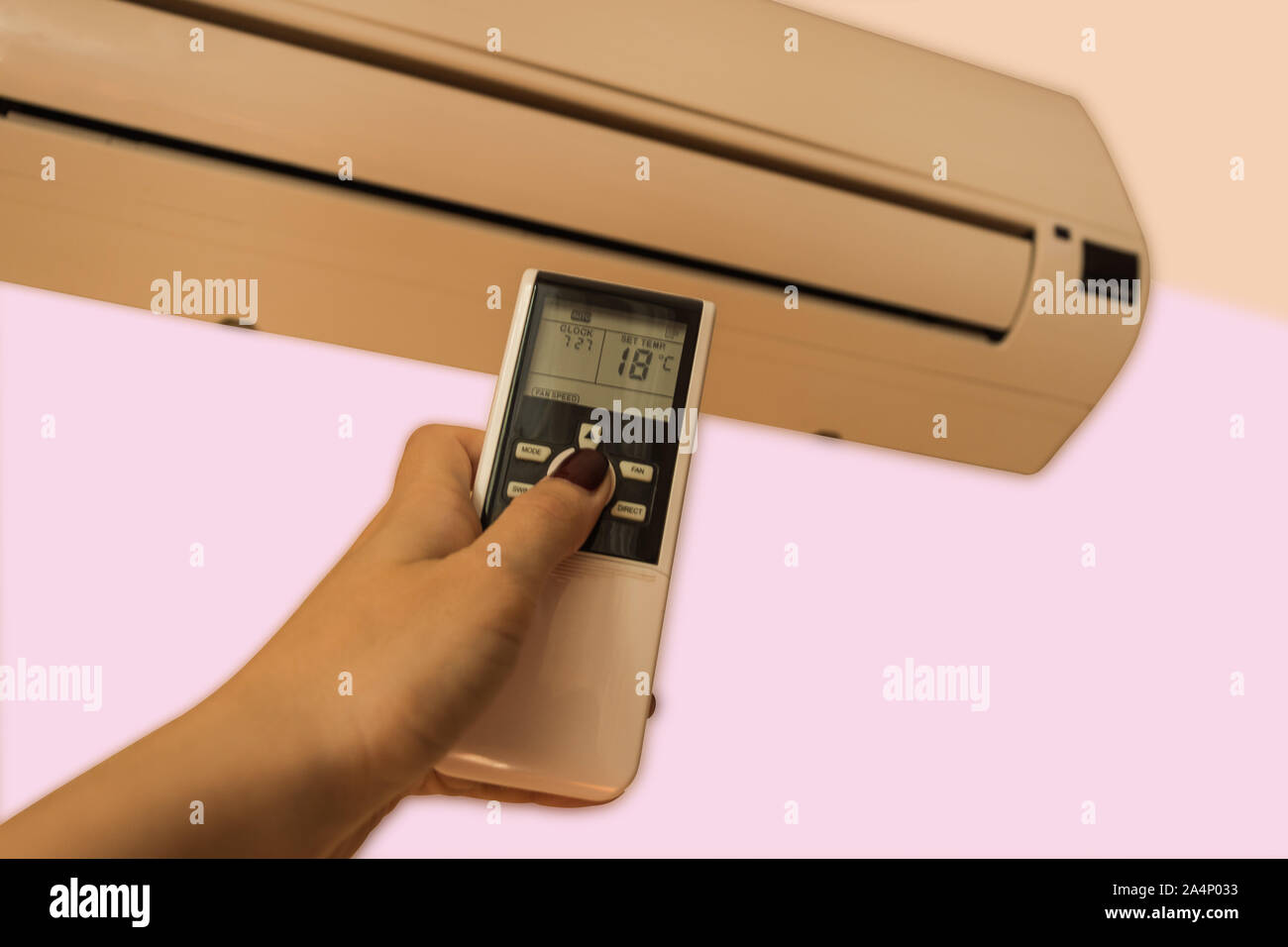 Woman hand using air conditioner remote controller. Air temperature ...